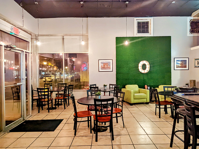 The bright, airy dining space features a statement green wall&mdash;a playful nod to the restaurant's name that anchors the room.