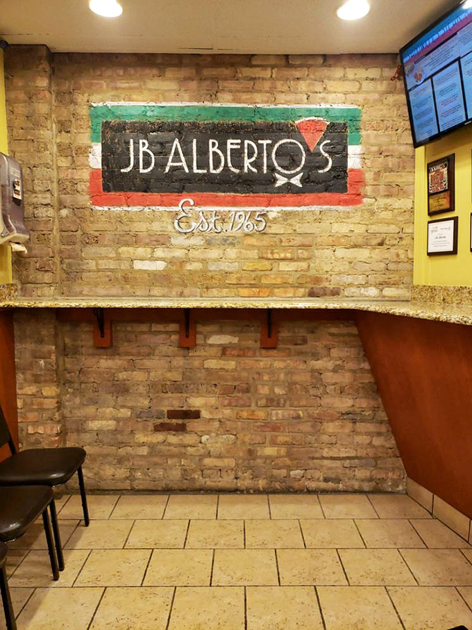The exposed brick wall bearing the J.B. Alberto's logo tells you this place has history, without needing to brag about it.