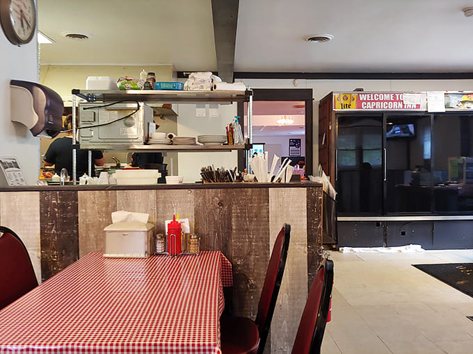 The kitchen pass reveals the organized chaos where burger magic happens&mdash;handwritten tickets and plates lined up like soldiers awaiting deployment.