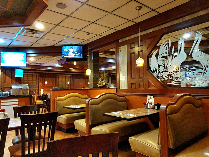 Wood paneling and etched glass cranes—diner décor that whispers, "The 1980s called and said you're welcome for the ambiance."