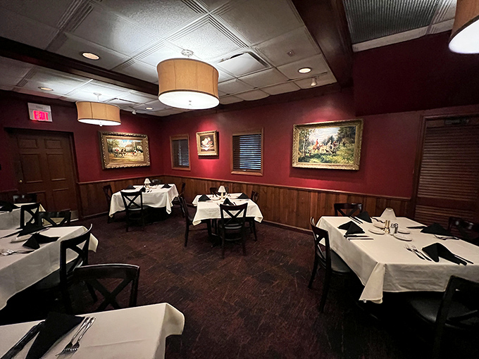 The dining room's rich burgundy walls and classic artwork create the perfect backdrop for important life decisions, like "medium-rare or rare?" 