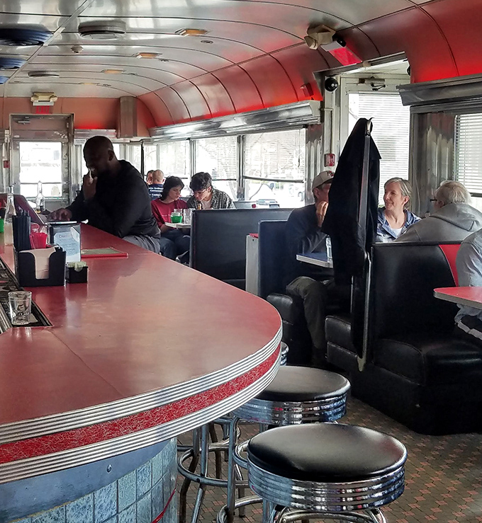 Inside the diner section, red booths and counter seating create that perfect nostalgic atmosphere where strangers become friends over coffee and pie.