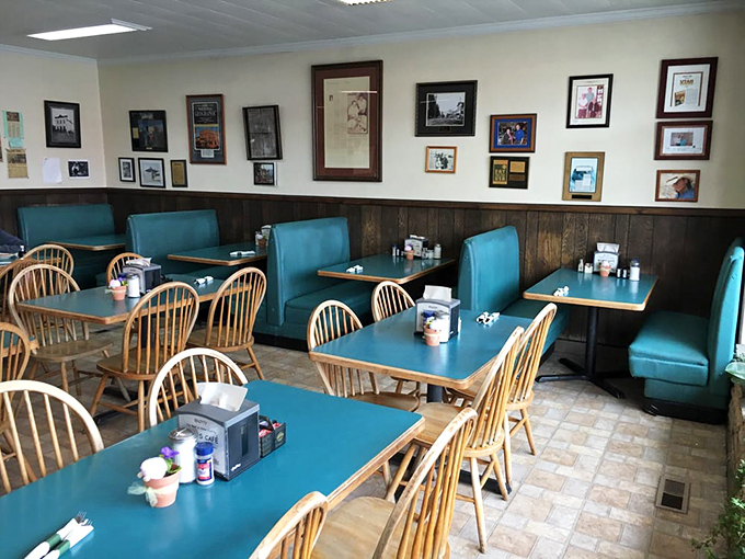 The dining room balances comfort and practicality with its turquoise booths and wooden chairs – a gallery wall of memories watching over countless family meals.
