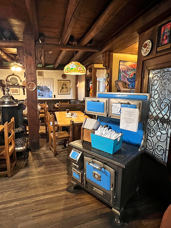 Vintage stoves and Tiffany-style lamps create an atmosphere where time slows down just enough to savor every bite.