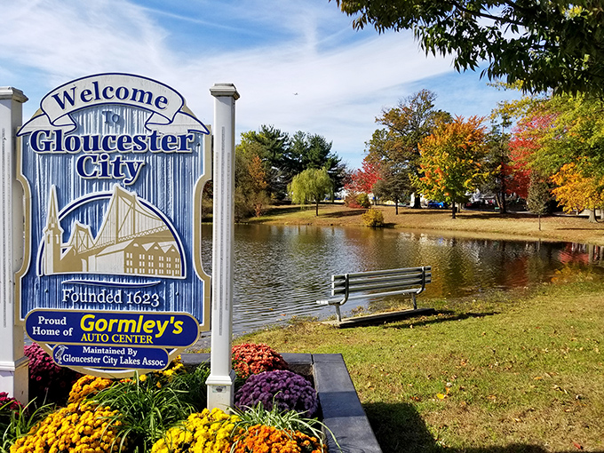 Johnson Park's welcome sign and serene lake create a picture-perfect setting for cost-conscious retirees who prefer natural beauty to overpriced resort amenities.