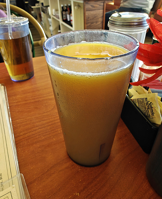 Orange juice in a proper diner glass &ndash; cold, bright, and promising vitamin C to counterbalance whatever else you're about to consume.