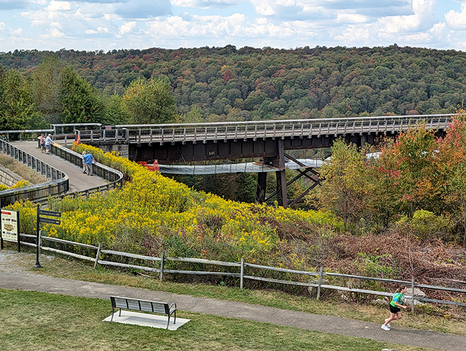 The skywalk stretches toward autumn's embrace, proving Pennsylvania doesn't need New England to put on a spectacular fall show.