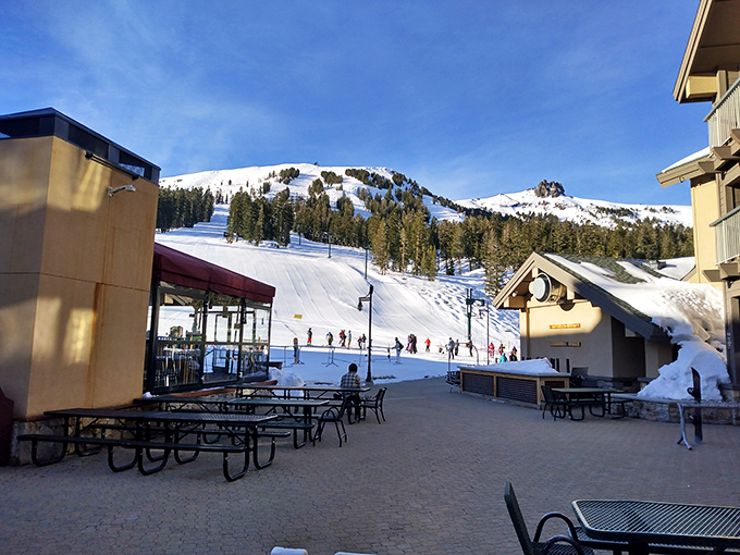 Kirkwood's village plaza—where après-ski dreams are made. Those picnic tables have heard more "best day ever" stories than a therapist.