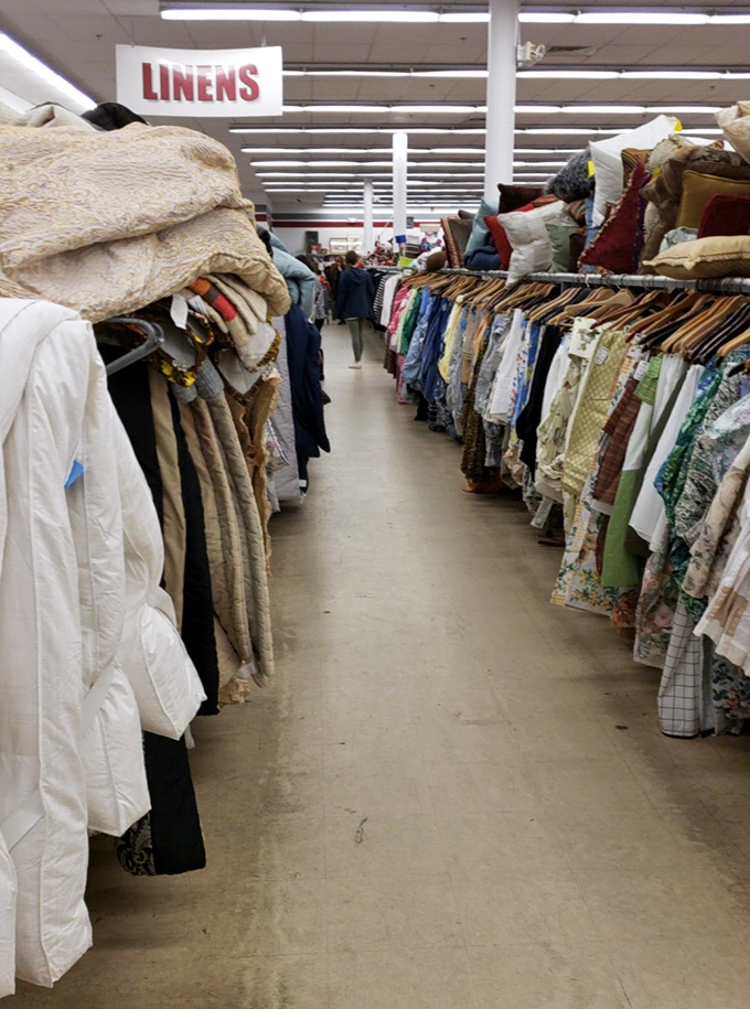 The linen aisle: where bedsheets and tablecloths from every decade gather for their class reunion. Patterns your grandmother would recognize line up for inspection.
