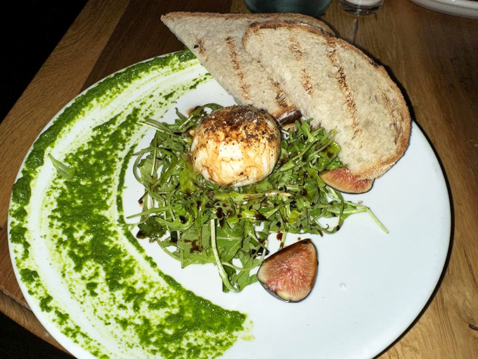 Burrata that's having an identity crisis – is it cheese or is it heaven? Either way, those figs aren't complaining.