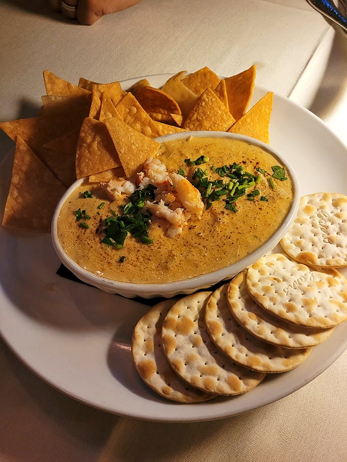 Lobster and crab united in creamy matrimony, surrounded by a congregation of crackers and chips eager to take the plunge.