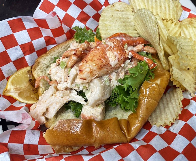 A lobster roll that doesn't need New England's permission to be magnificent. The red-checkered paper is its natural habitat.