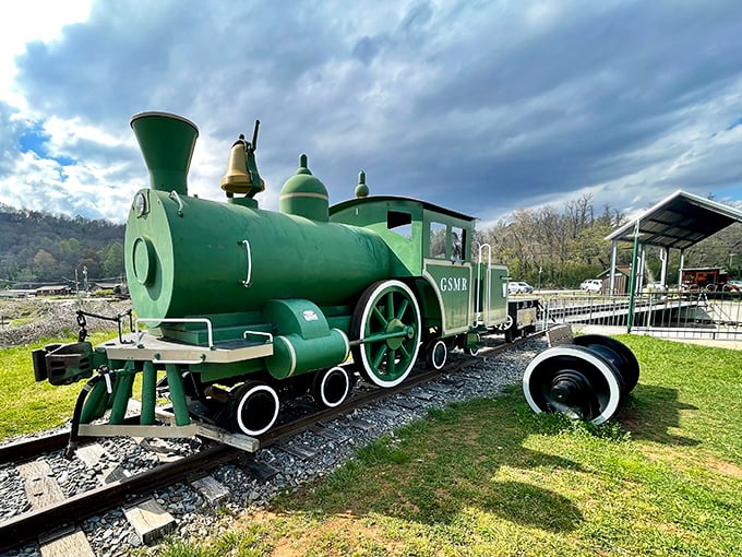 This emerald beauty isn't going anywhere fast! A preserved vintage locomotive stands as a colorful monument to railroad engineering.