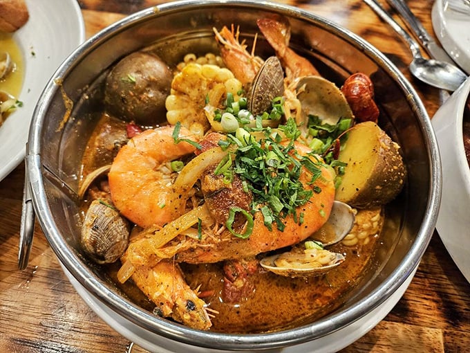 The Louisiana boil: a treasure chest of oceanic delights. Clams, shrimp, and potatoes bathing in spiced broth that could make a sailor weep with joy.