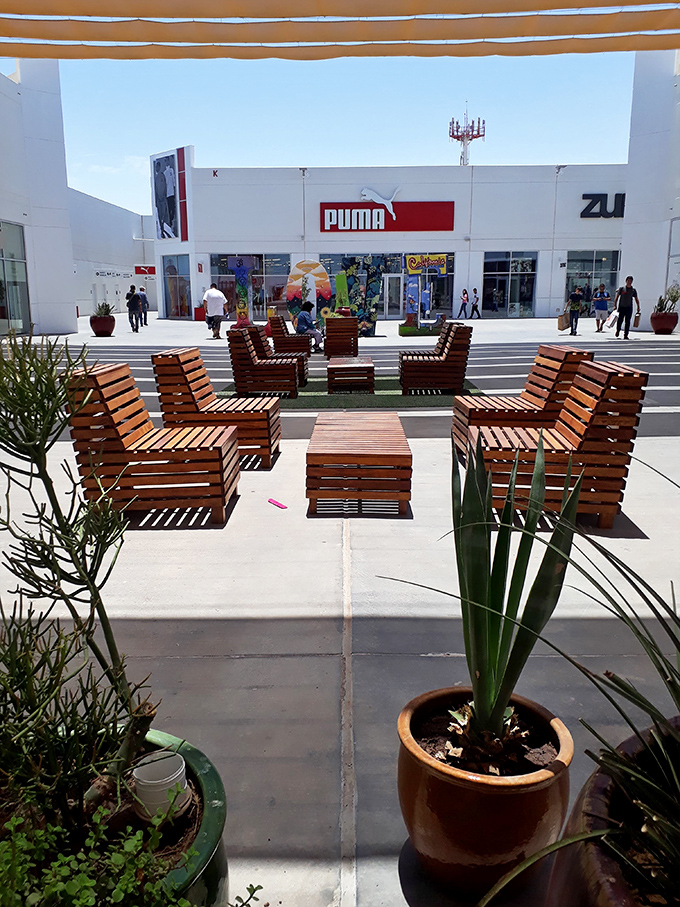 Puma's storefront anchors a thoughtfully designed seating area where weary shoppers can rest their feet before embarking on the next round of retail adventures.