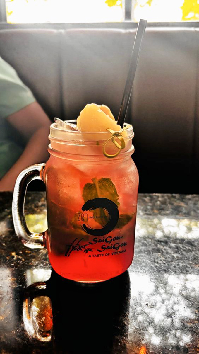 This isn't just a lychee mojito; it's summer in a mason jar, complete with fresh fruit and mint that transports you straight to vacation mode.