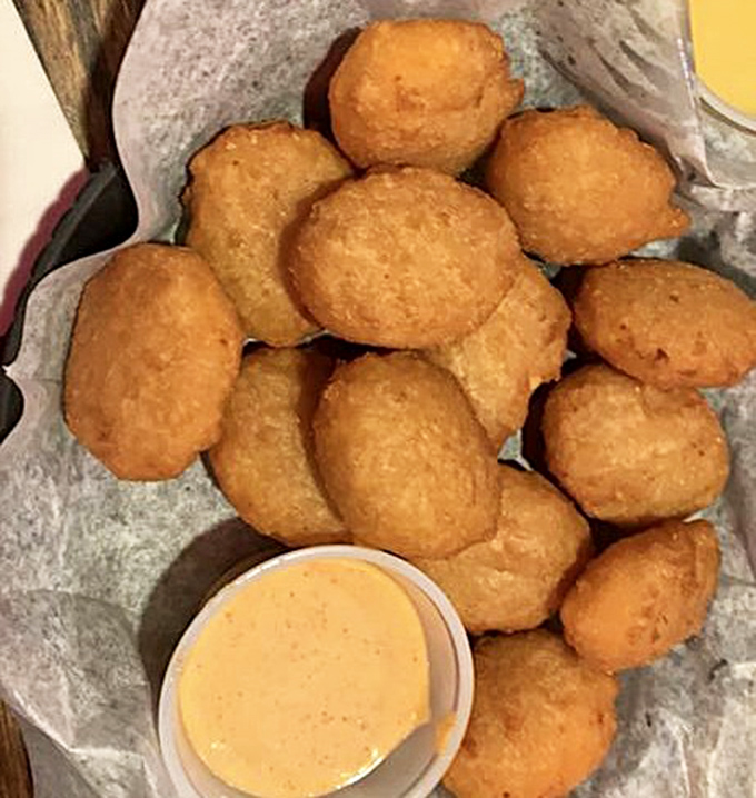 Mac & cheese bites: where comfort food gets dressed up for a night out, golden-fried and ready for their dipping sauce dance partner.