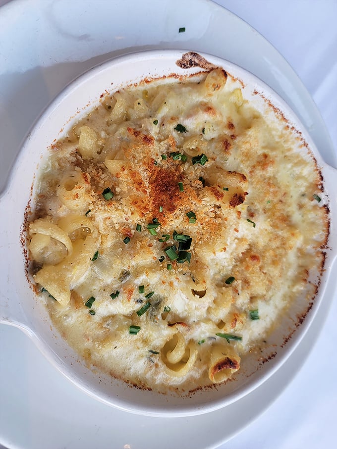 Mac and cheese that's had a glow-up worthy of a Hollywood makeover. That golden crust is hiding treasures beneath&mdash;seafood secrets worth discovering.
