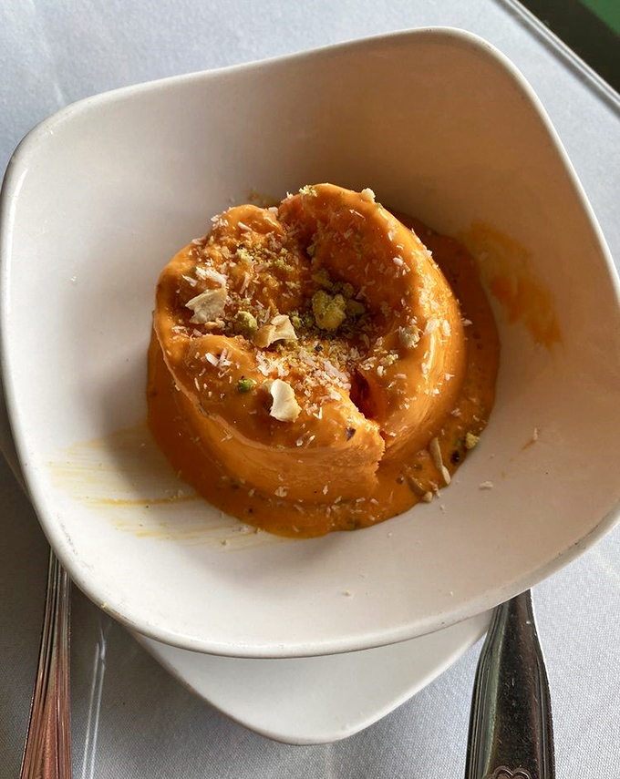 This mango kulfi isn't just frozen—it's contemplative. The pistachios aren't merely toppings; they're exclamation points on a sweet soliloquy.