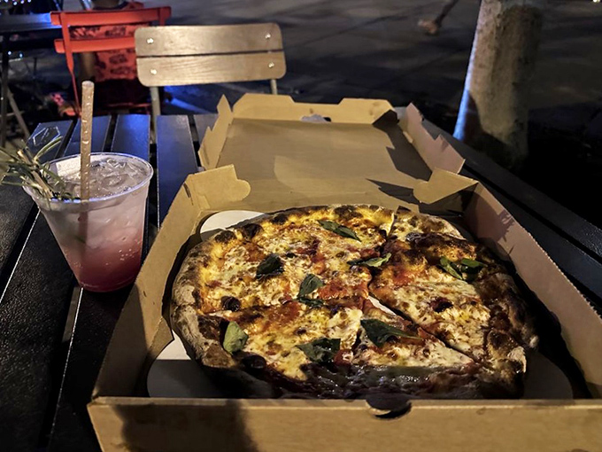 The classic Margherita in its to-go glory &ndash; proof that sometimes the simplest combination of tomato, cheese, and dough creates the most profound pleasure.
