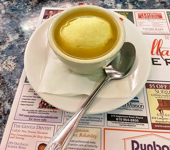 A bowl of matzo ball soup that could cure anything from a common cold to existential dread—comfort in liquid form.