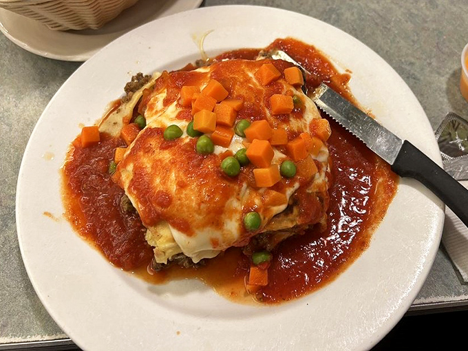 Lasagna with a blanket of melted cheese and vegetables that counts as a serving of happiness. Comfort food that hugs you from the inside.