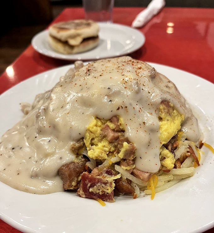 Country gravy cascading over eggs and potatoes like a savory waterfall. Comfort food that hugs your insides on a chilly Moscow morning.