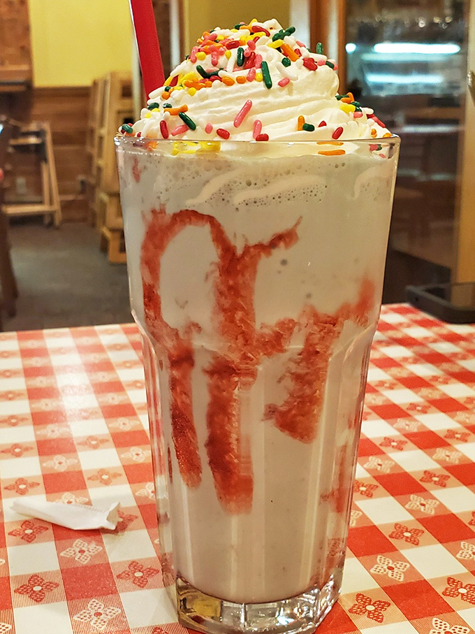 This isn't just a milkshake; it's a carnival in a glass, complete with whipped cream mountains and sprinkle confetti.