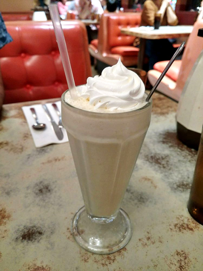 A milkshake so thick and creamy it deserves its own zip code. That whipped cream crown is just showing off.