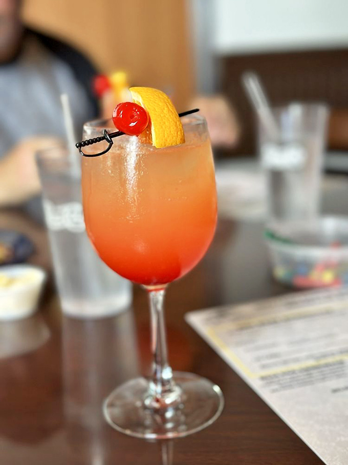 Sunrise in a glass! This vibrant cocktail with its cherry garnish isn't just a drink &ndash; it's the official announcement that vacation mode has begun.