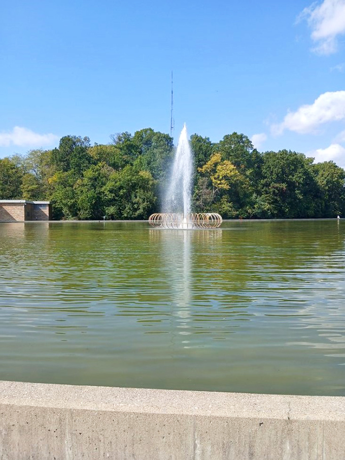 Mirror Lake's fountain reaches skyward, creating a hypnotic dance of water that's been mesmerizing visitors since the park's earliest days.