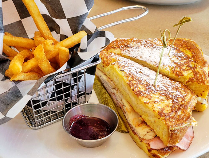 The Monte Cristo: where breakfast and lunch have a delicious affair, resulting in French toast stuffed with ham and cheese, served with fries.