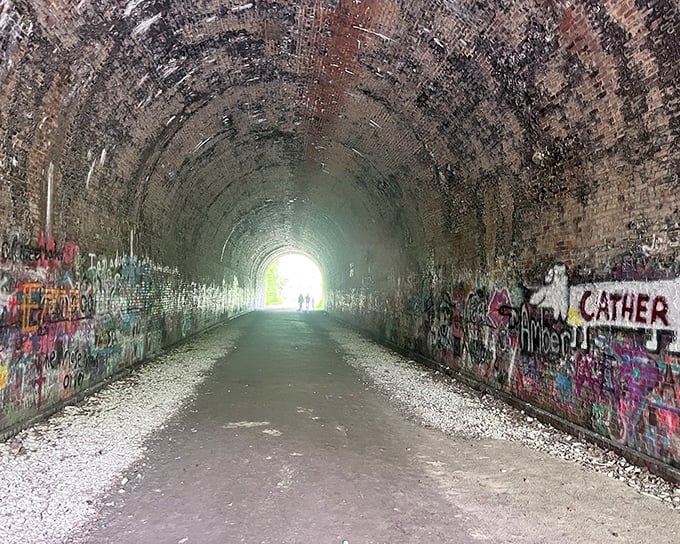 Graffiti artists have made their mark inside the tunnel, creating an ever-evolving gallery where industrial history meets contemporary expression.