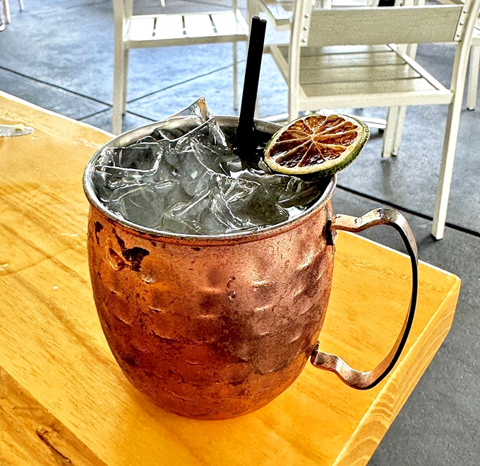 A Moscow Mule that gleams in its copper mug like liquid sunshine, complete with a charred citrus garnish for that extra bit of flair.