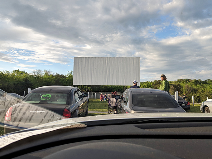 The blank screen awaits dusk's arrival, standing tall against Tennessee's rolling hills&mdash;cinema's most patient performer ready for its nightly star turn.