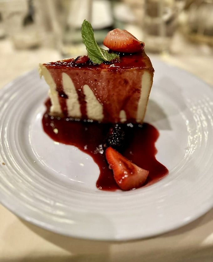 New York cheesecake with berry sauce and fresh strawberries&mdash;rich, creamy, and absolutely worth saving room for after all that seafood.