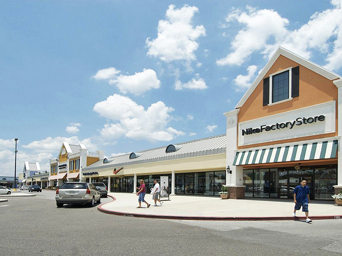 Nike Factory Store anchors the corner, its iconic swoosh beckoning to sneakerheads and weekend warriors alike.