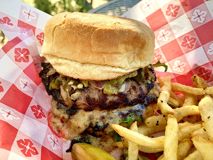 Some burgers wear checkered tablecloths like formal attire. The golden fries are the perfect supporting cast to this handcrafted masterpiece.