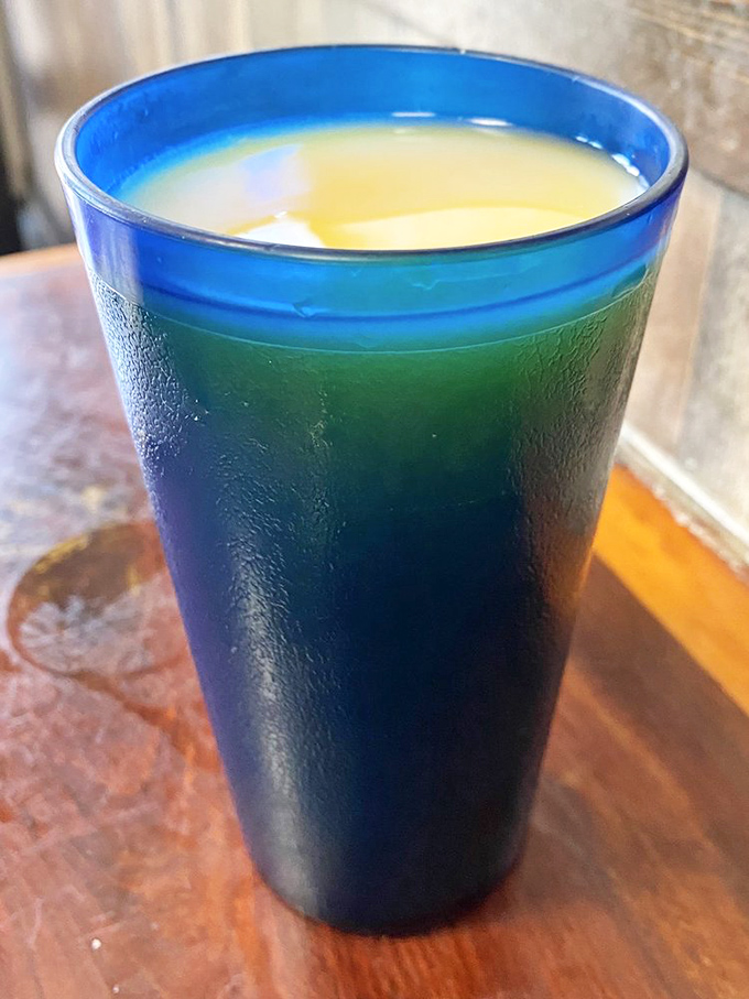 That distinctive blue glass&mdash;a Sugar Shack signature&mdash;filled with what appears to be orange juice. Morning sunshine in liquid form.