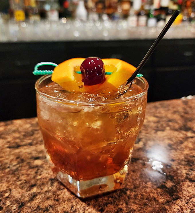 An Old Fashioned garnished with orange and cherry &ndash; because great Italian food deserves equally thoughtful cocktail companionship.