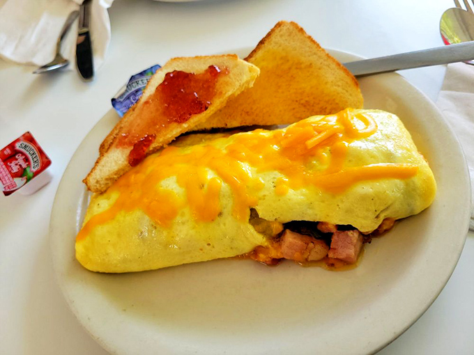 An omelet that's practically bursting with fillings, paired with toast that's ready for its supporting role in this breakfast drama.