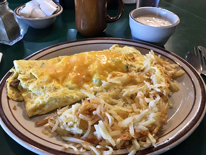 This omelet and hash browns combo isn't just breakfast&mdash;it's edible sunshine. The cheese pull alone deserves its own Instagram account.