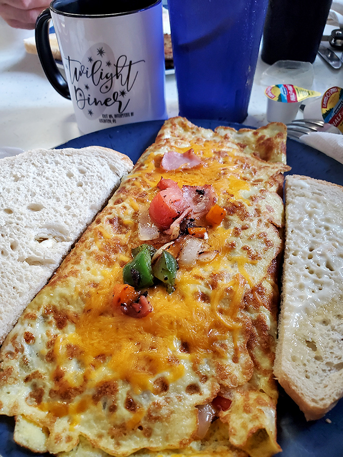 An omelet that's seen things &ndash; stuffed with colorful vegetables and cheese, flanked by toast soldiers ready for the breakfast battlefield.