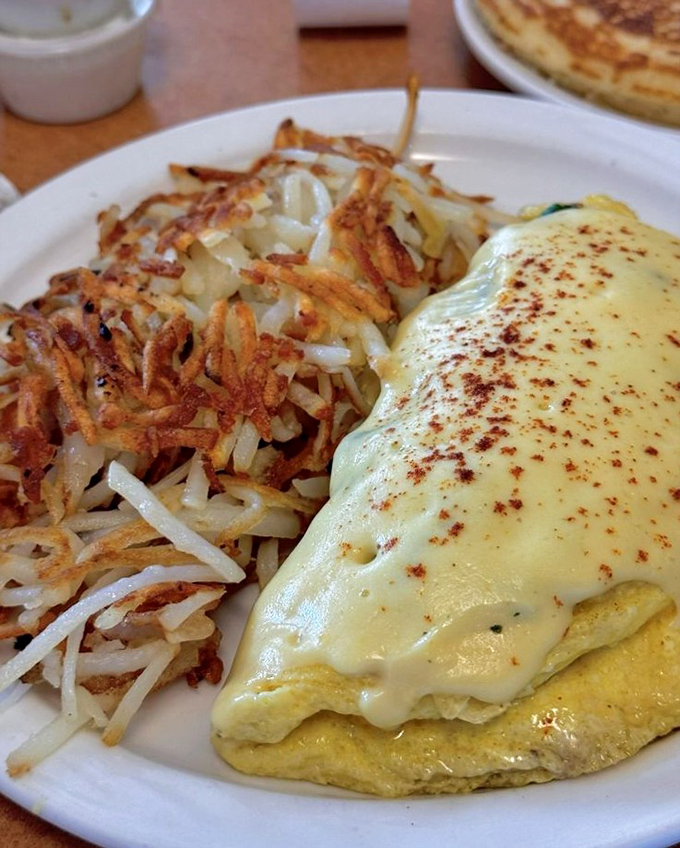 This omelet draped in hollandaise with crispy hash browns is breakfast's answer to formal evening wear.