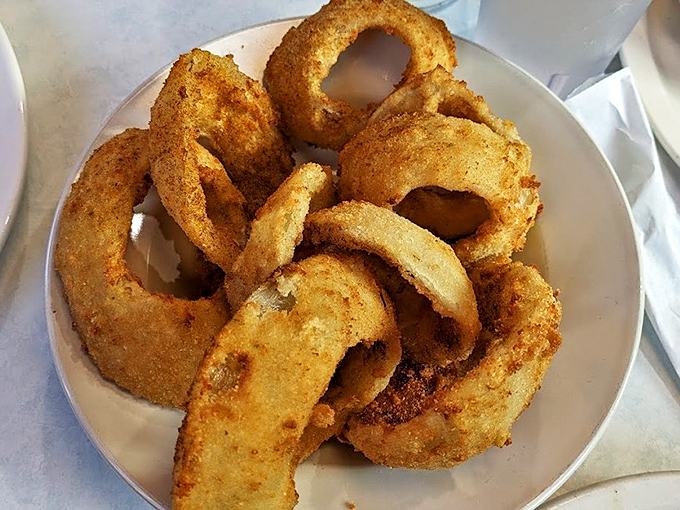 Onion rings with the structural integrity of Olympic medals and twice the gold color. Worth every napkin you'll need.