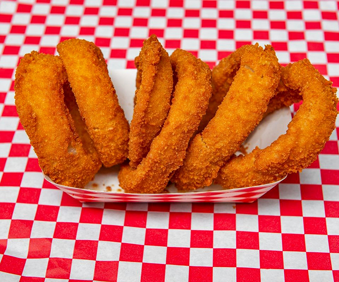 Onion rings stacked like delicious golden halos, proving that sometimes the best things in life are circular, crispy, and slightly bad for you.