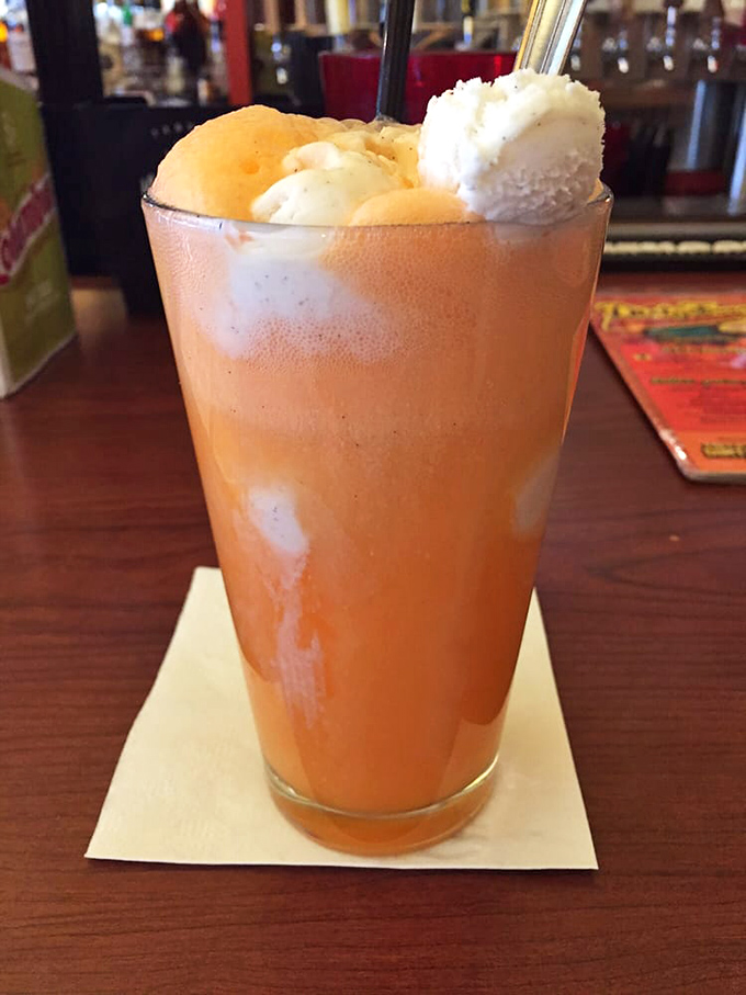 Ice cream floating in orange soda like delicious icebergs in a sea of fizzy delight. Nostalgia and sugar rush in one gloriously tall glass. 
