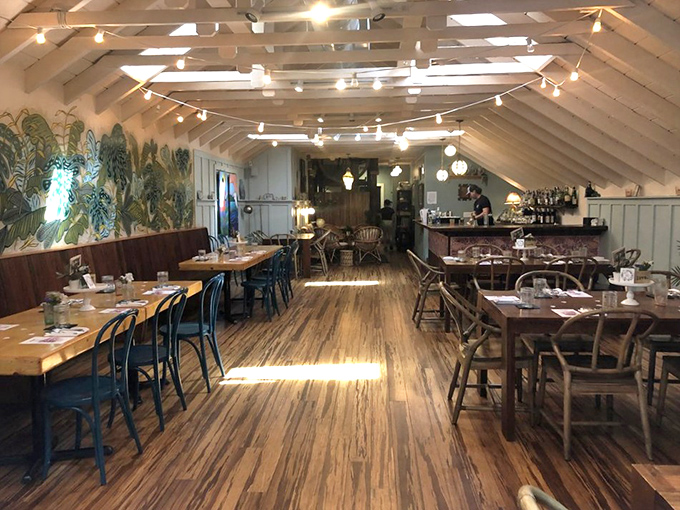 String lights and wooden beams create a dining room that feels like the best beach house you've never owned but always wanted.