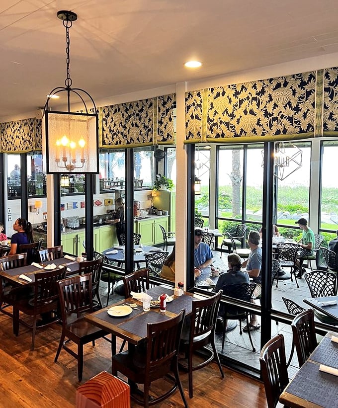 Coastal elegance meets homey comfort. The dining room's shell-patterned valances and abundant natural light create an atmosphere that says "stay awhile."