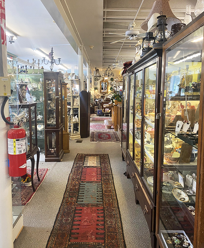 Oriental rugs guide you down aisles of glass-fronted cabinets, creating the feeling of wandering through a museum where everything, surprisingly, is for sale. 